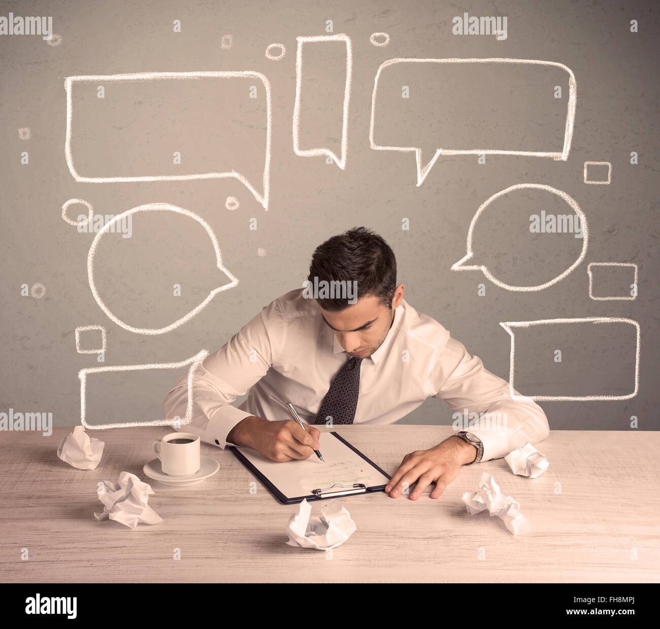 Busy office worker with drawn text bubbles Stock Photo - Alamy