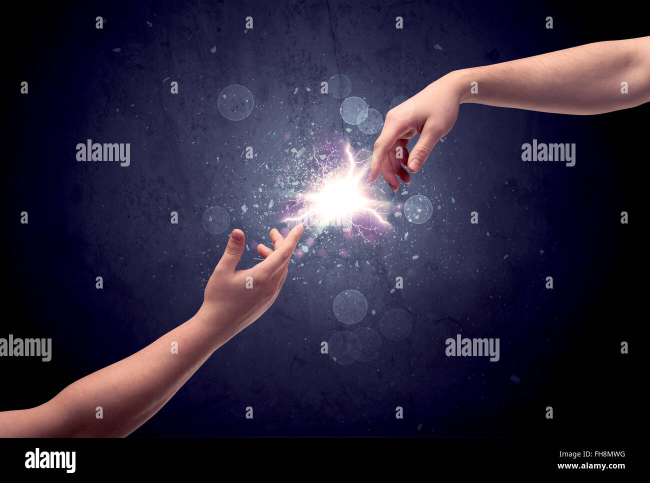 Hands reaching to light a spark Stock Photo - Alamy