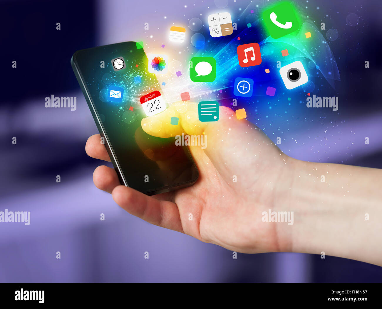 Hand holding smartphone with colorful app icons Stock Photo - Alamy