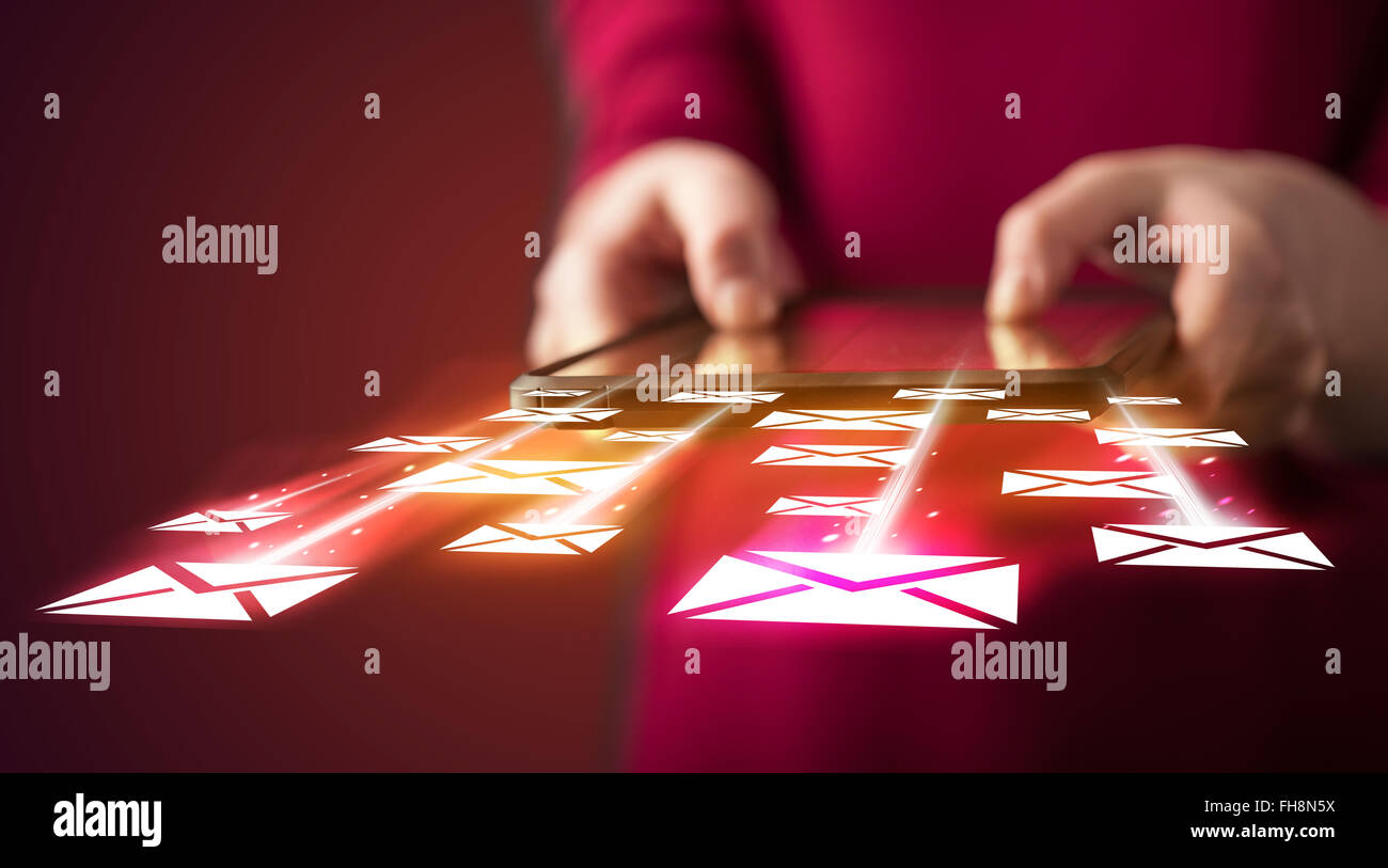 Hand holding tablet and sending email icons Stock Photo - Alamy