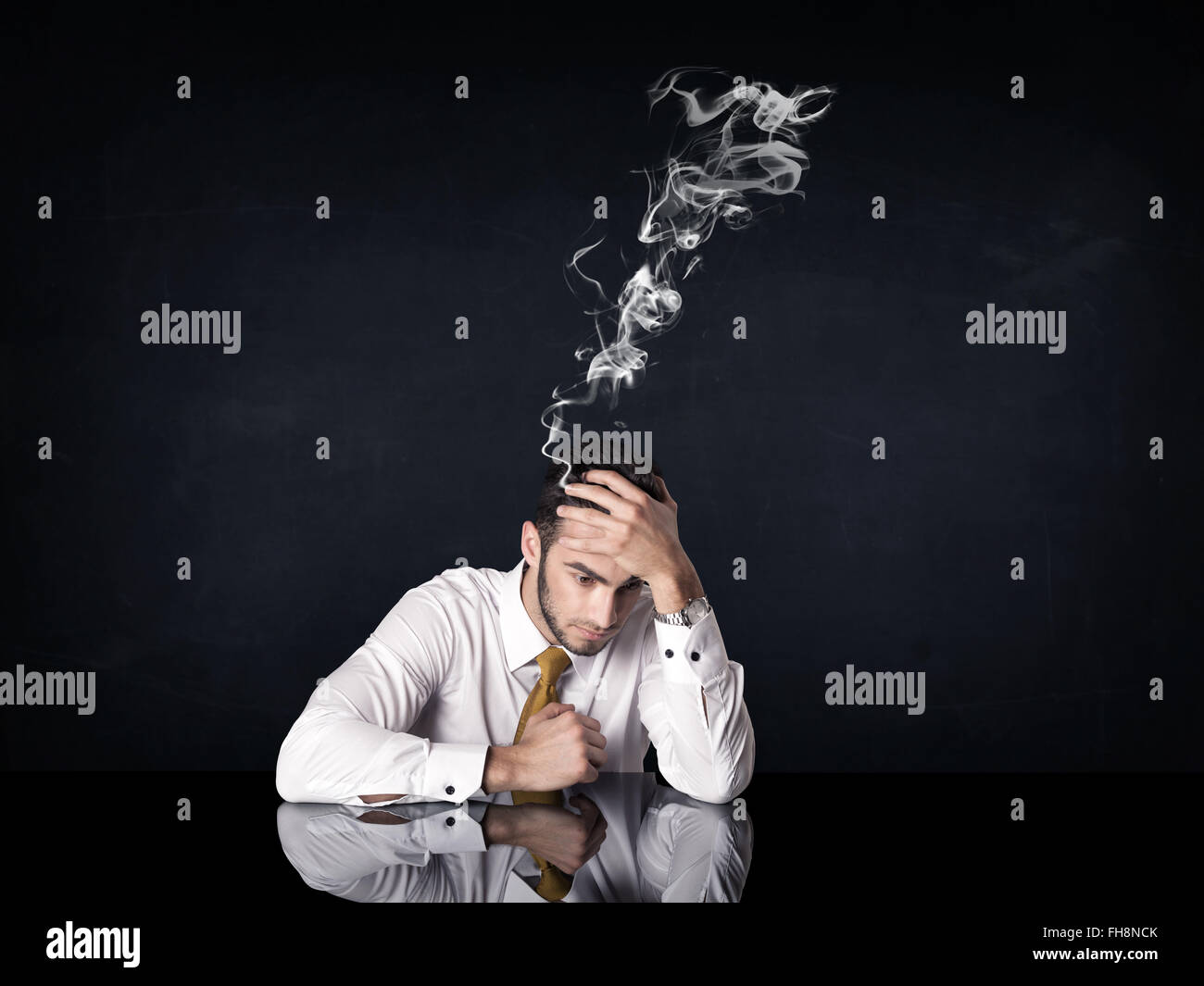 Depressed businessman with smoking head Stock Photo - Alamy