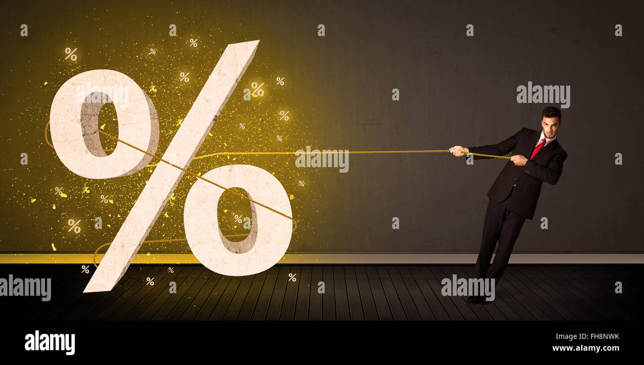 Business man pulling rope with big procent symbol sign Stock Photo - Alamy