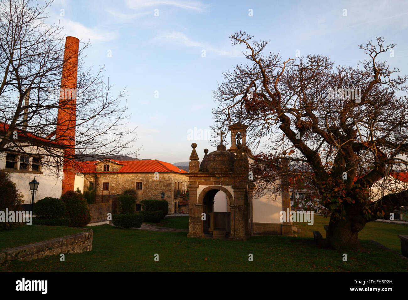 Church and old sweet chestnut tree (Castanea sativa) in winter, Vila ...
