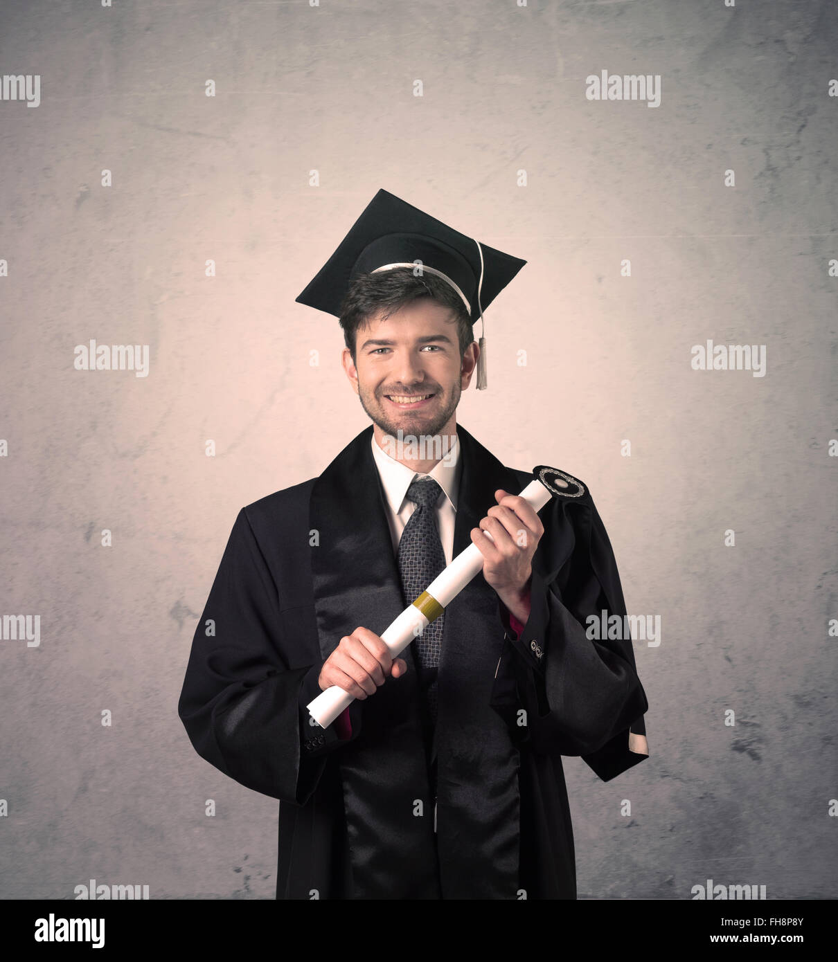 Portrait of a young graduate student on grungy background Stock Photo ...
