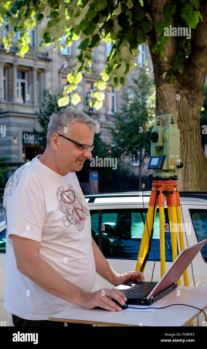 Land surveyor taking measures with Leica TCR 307 theodolite and laptop ...