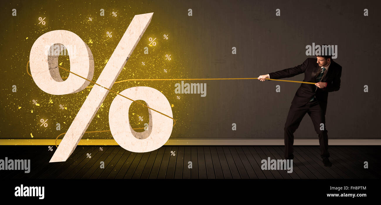 Business man pulling rope with big procent symbol sign Stock Photo - Alamy