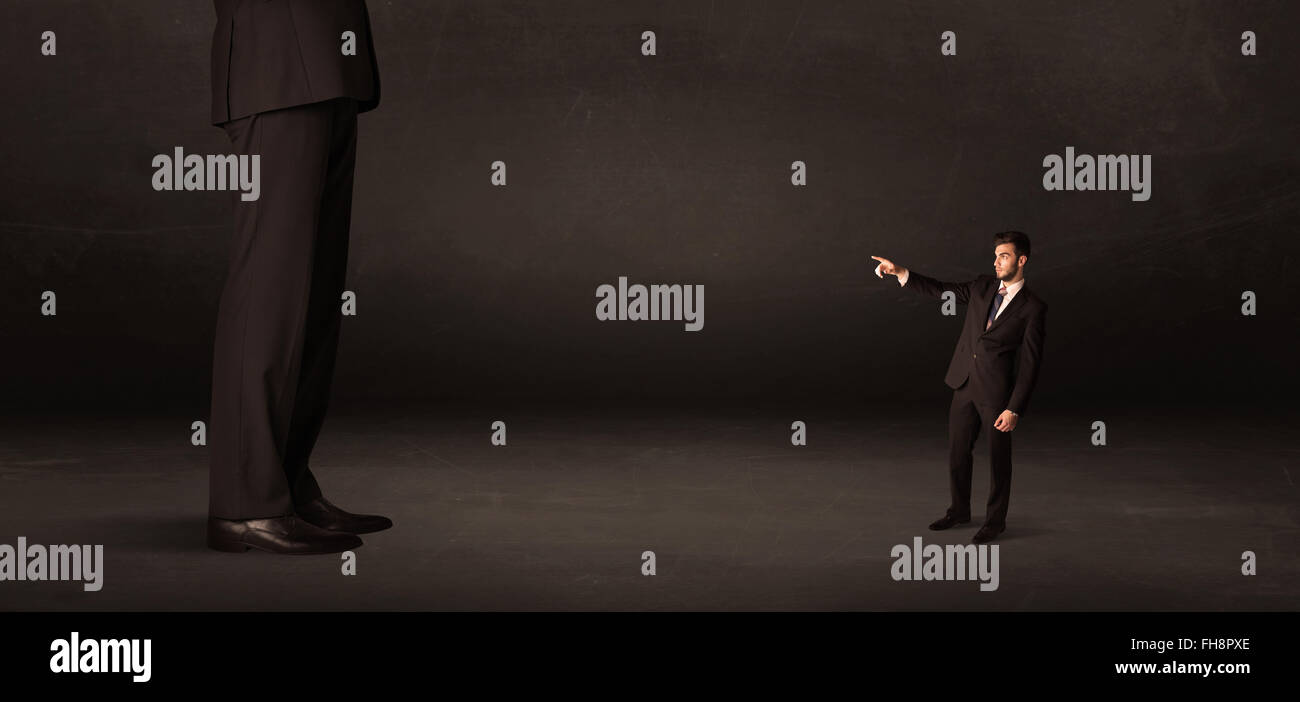Huge man with small businessman standing at front concept Stock Photo ...