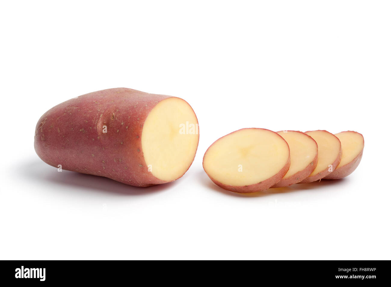 Fresh raw sliced Roseval potato on white background Stock Photo - Alamy