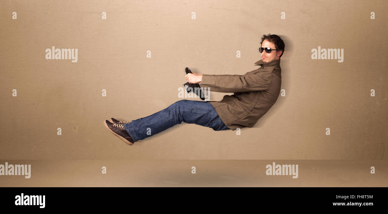 Happy funny man driving a flying car concept Stock Photo - Alamy