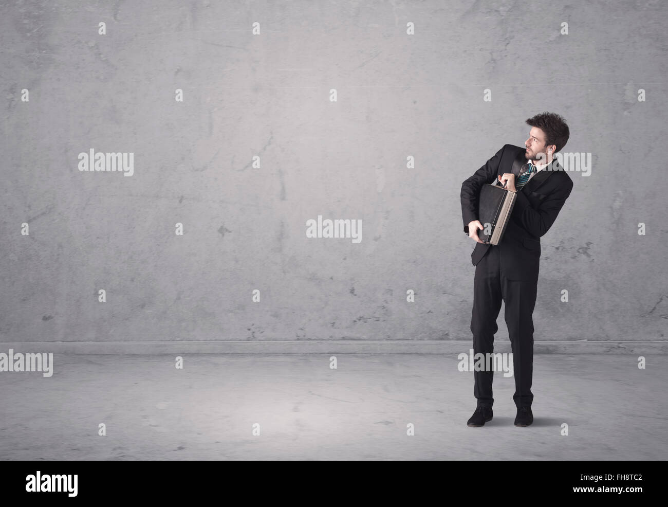Young businessman standing confused Stock Photo - Alamy