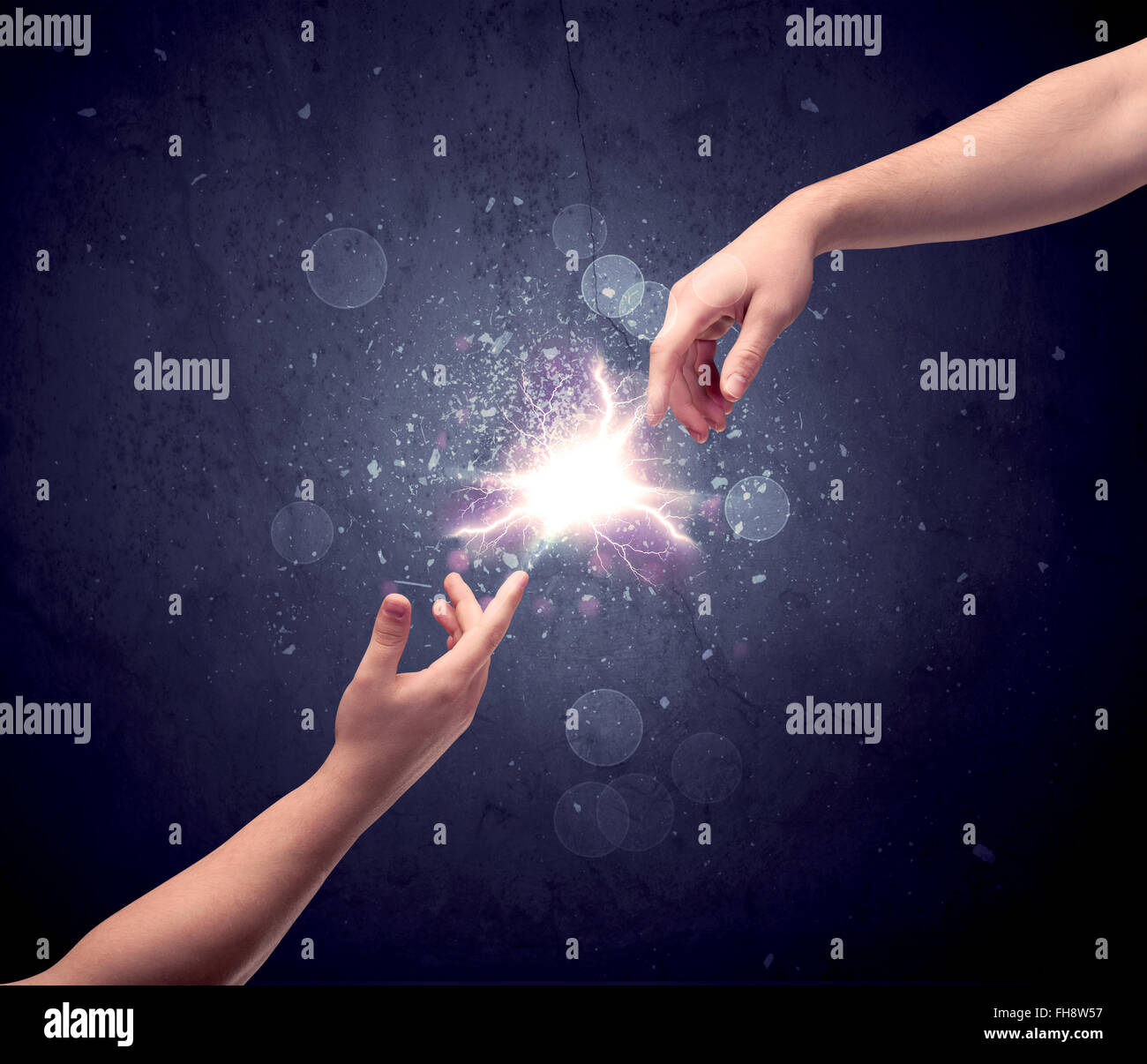 Hands reaching to light a spark Stock Photo - Alamy