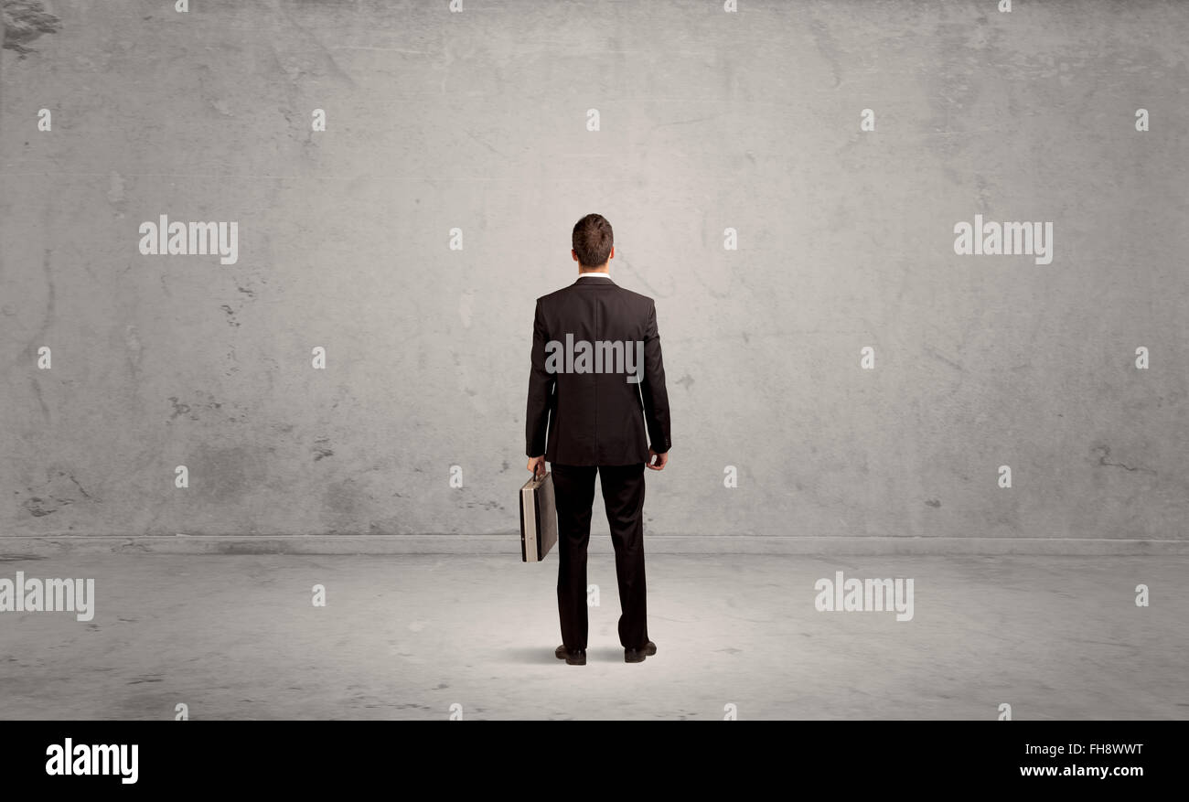 Businessman lost in empty urban space Stock Photo - Alamy