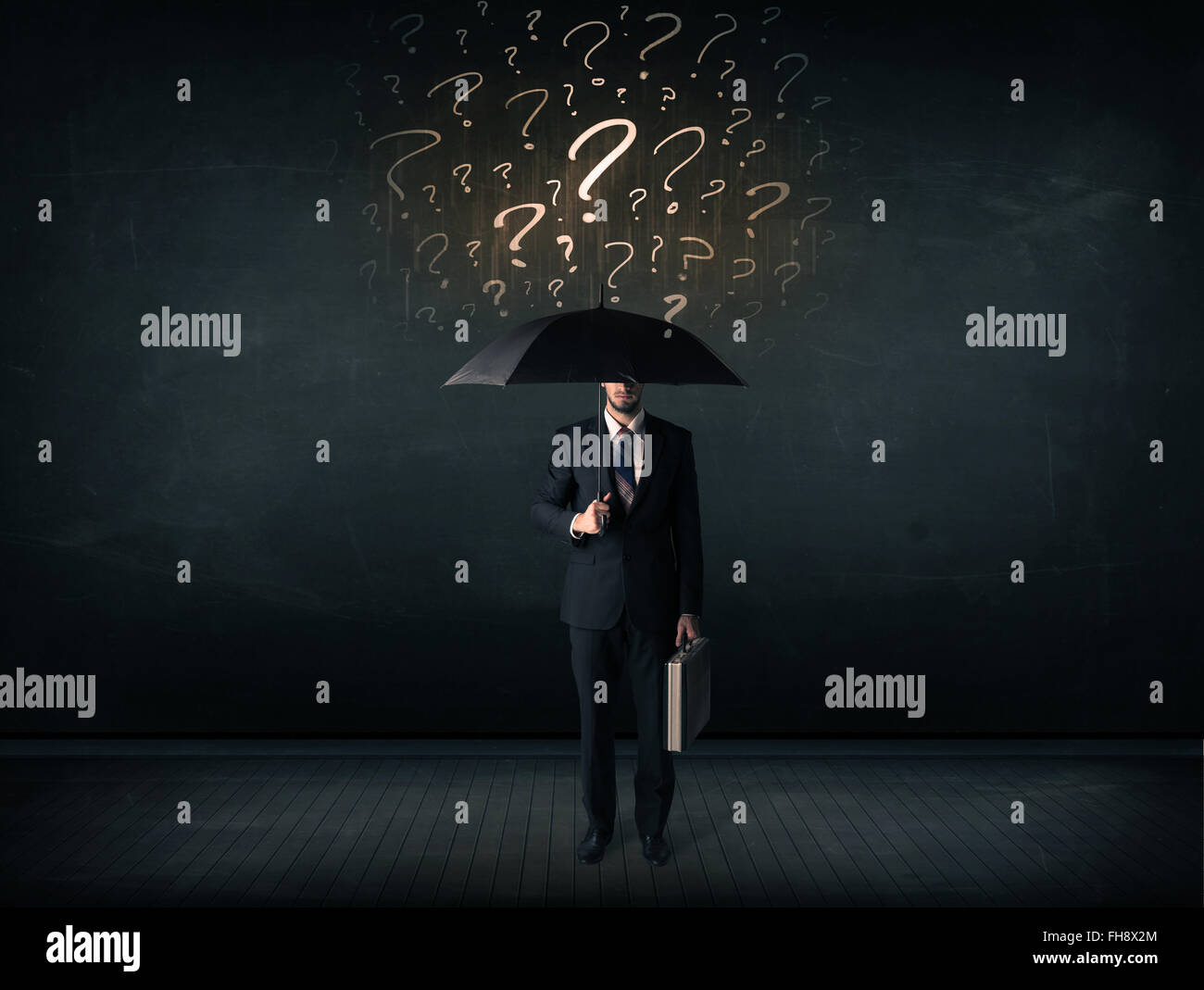Businessman with umbrella and a lot of drawn question marks Stock Photo ...