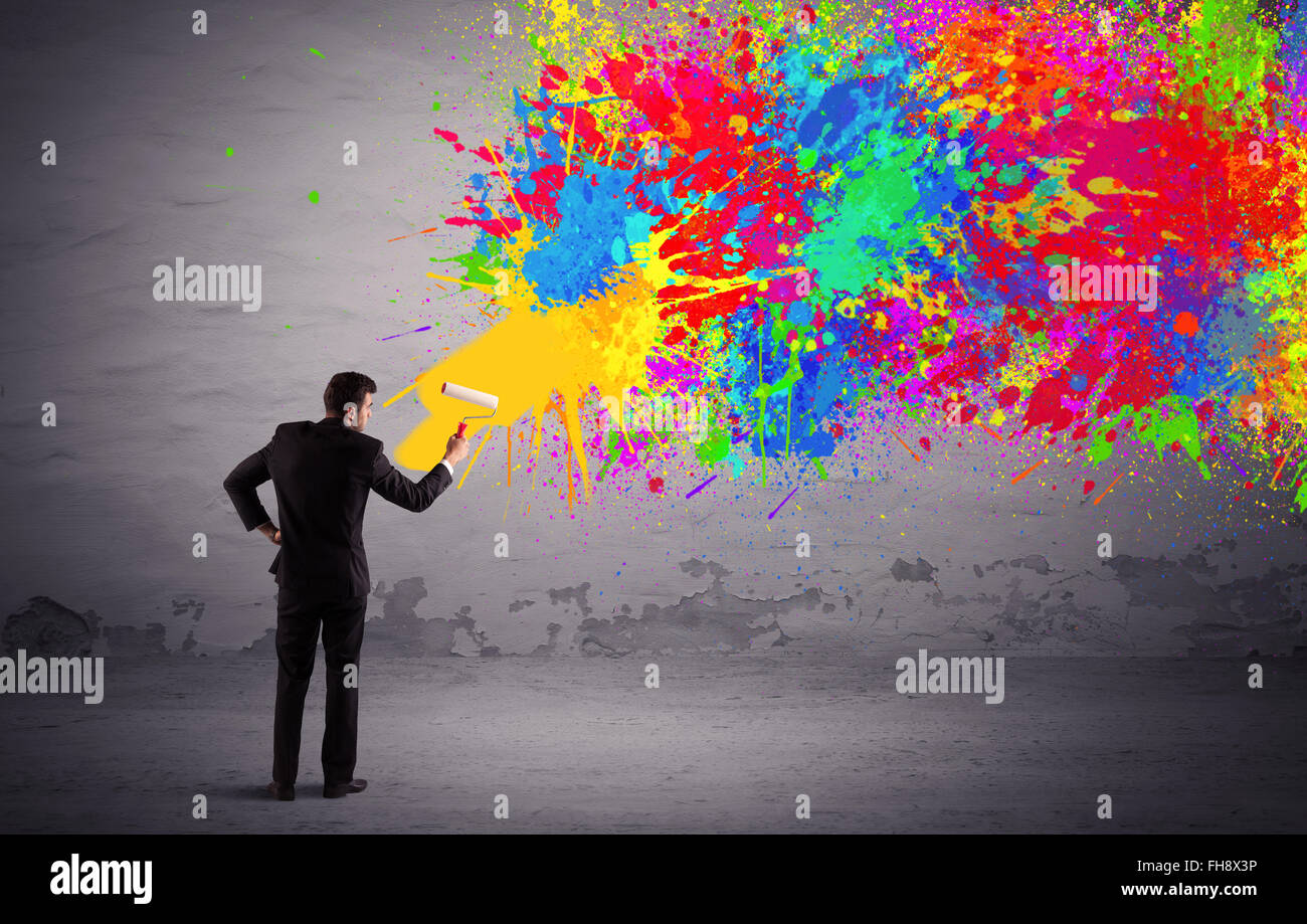 Sales person painting colorful splatter Stock Photo - Alamy