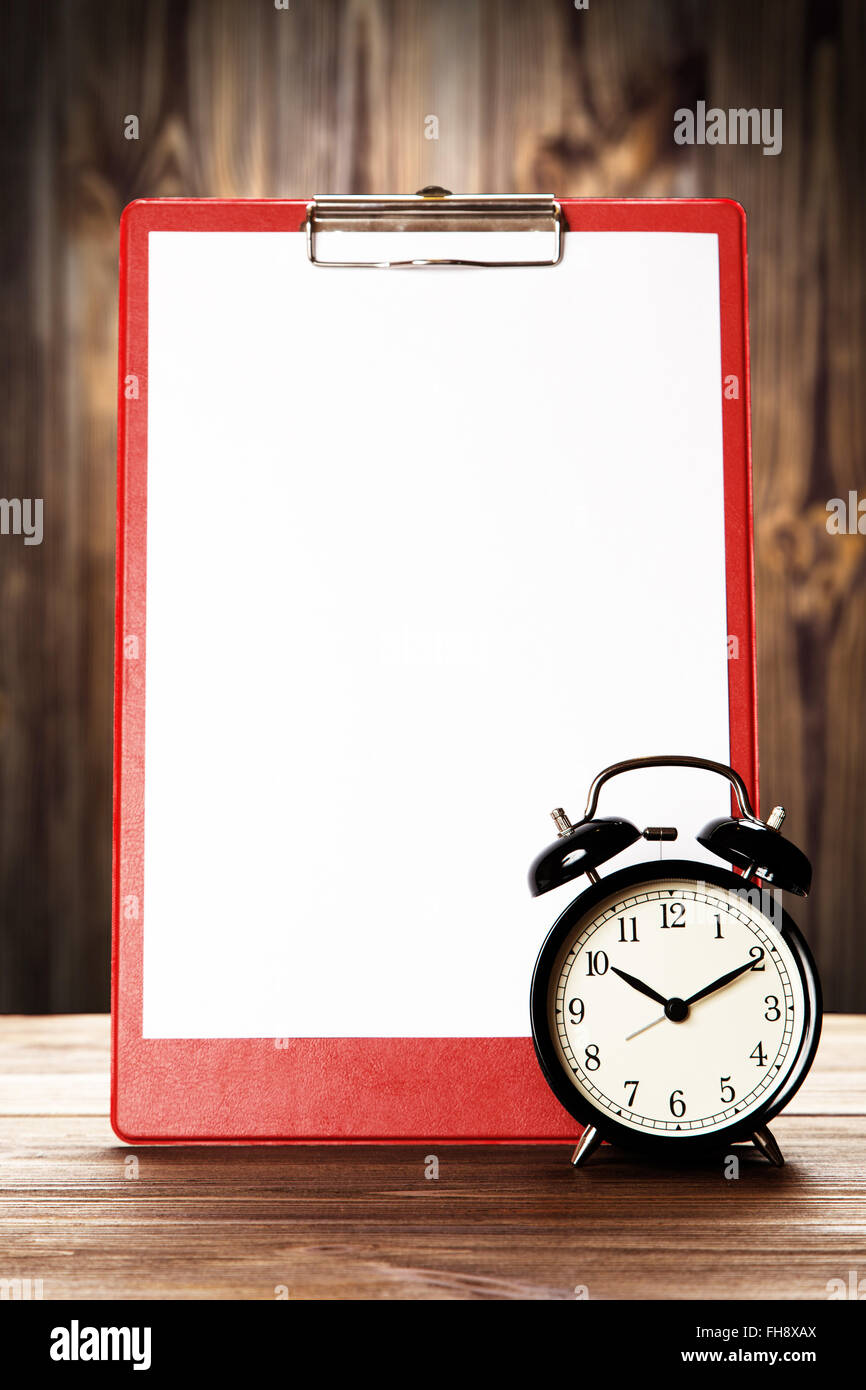 Blank paper sheet and alarm clock Stock Photo - Alamy