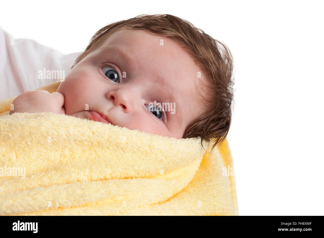 Cute little baby girl wrapped in a yellow towel on white background ...