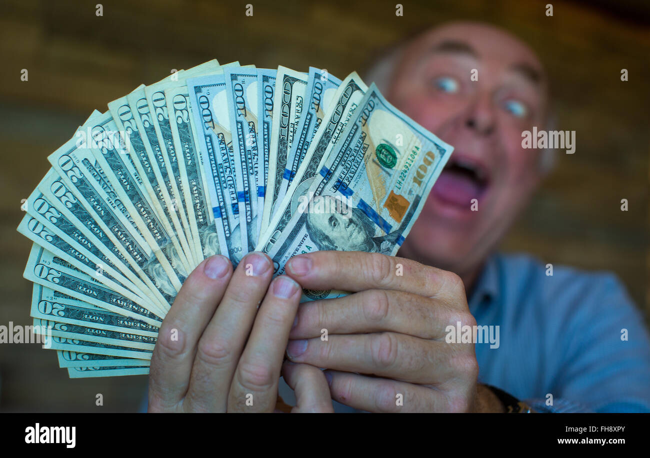 Man poses with US bank notes Stock Photo - Alamy