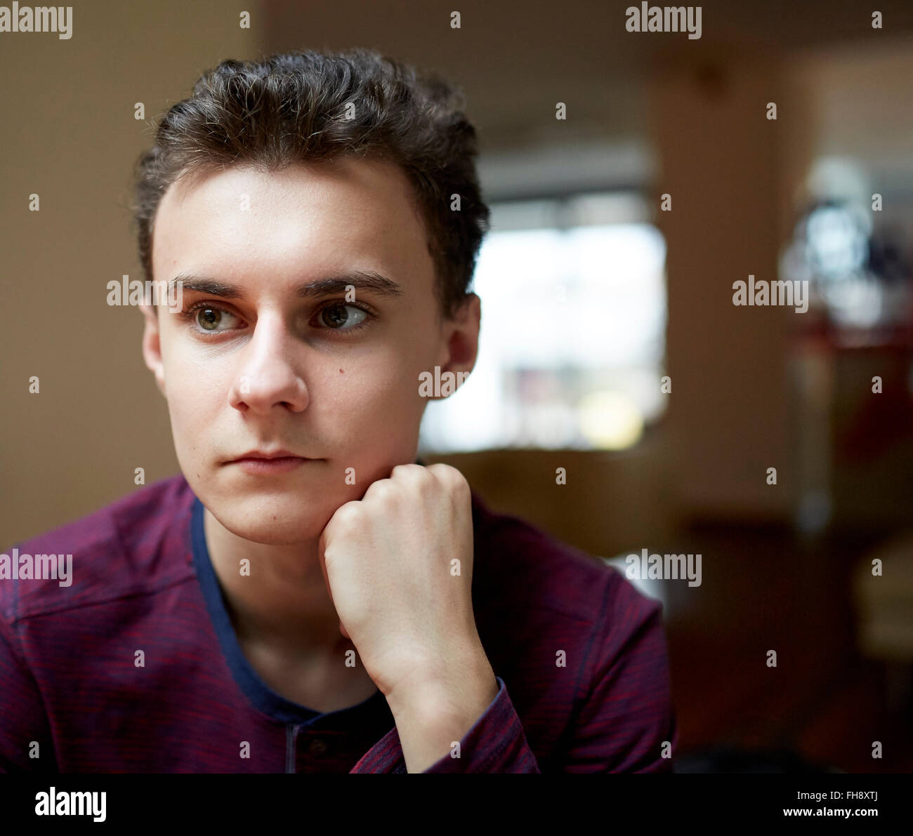 Closeup portrait of a pensive teenage boy indoor Stock Photo - Alamy