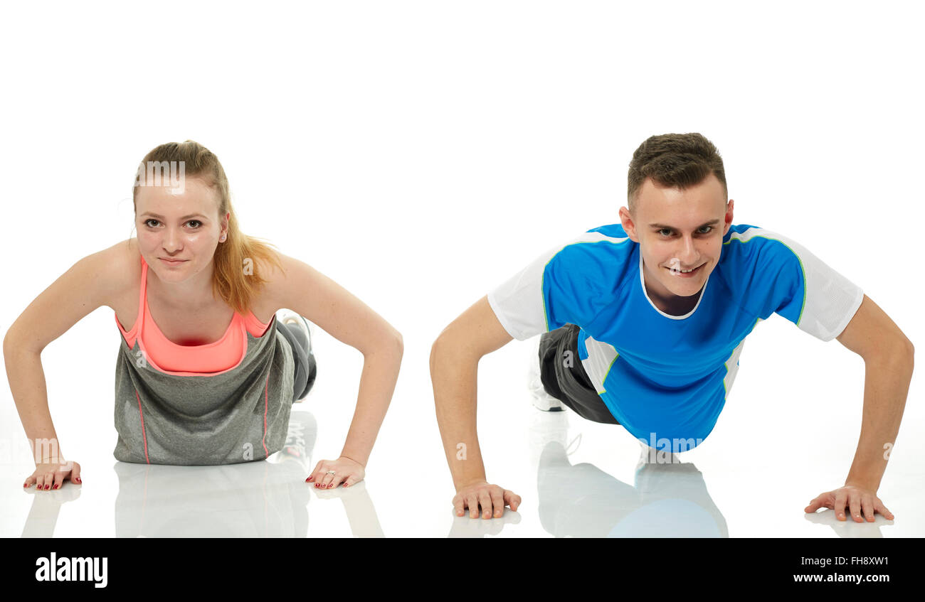 Teenagers boy and girl doing pushups isolated on white Stock Photo - Alamy