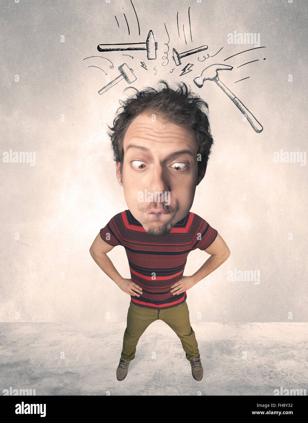 Big head person with drawn hammers Stock Photo - Alamy