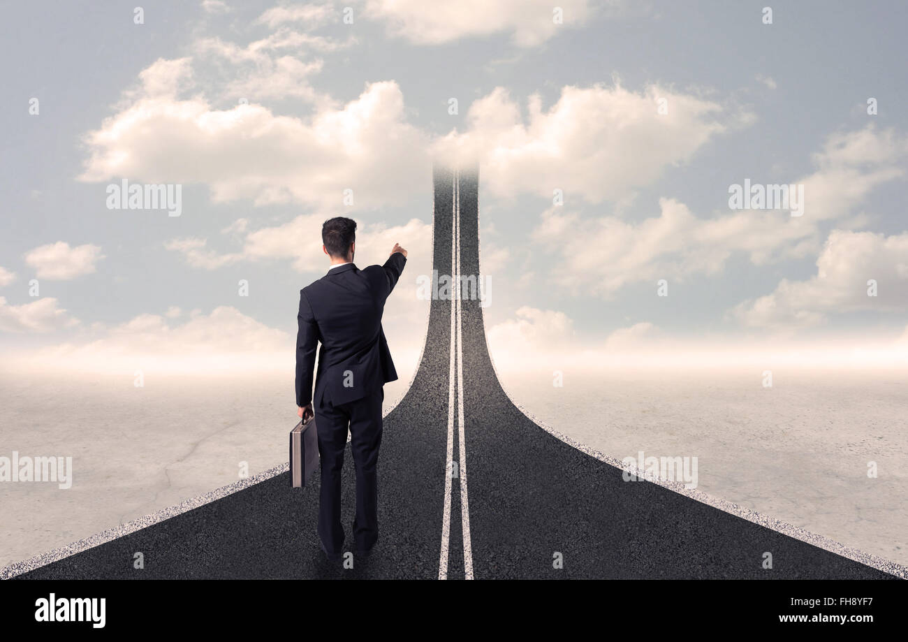 Businessman looking at 3d road that goes up in the sky Stock Photo - Alamy