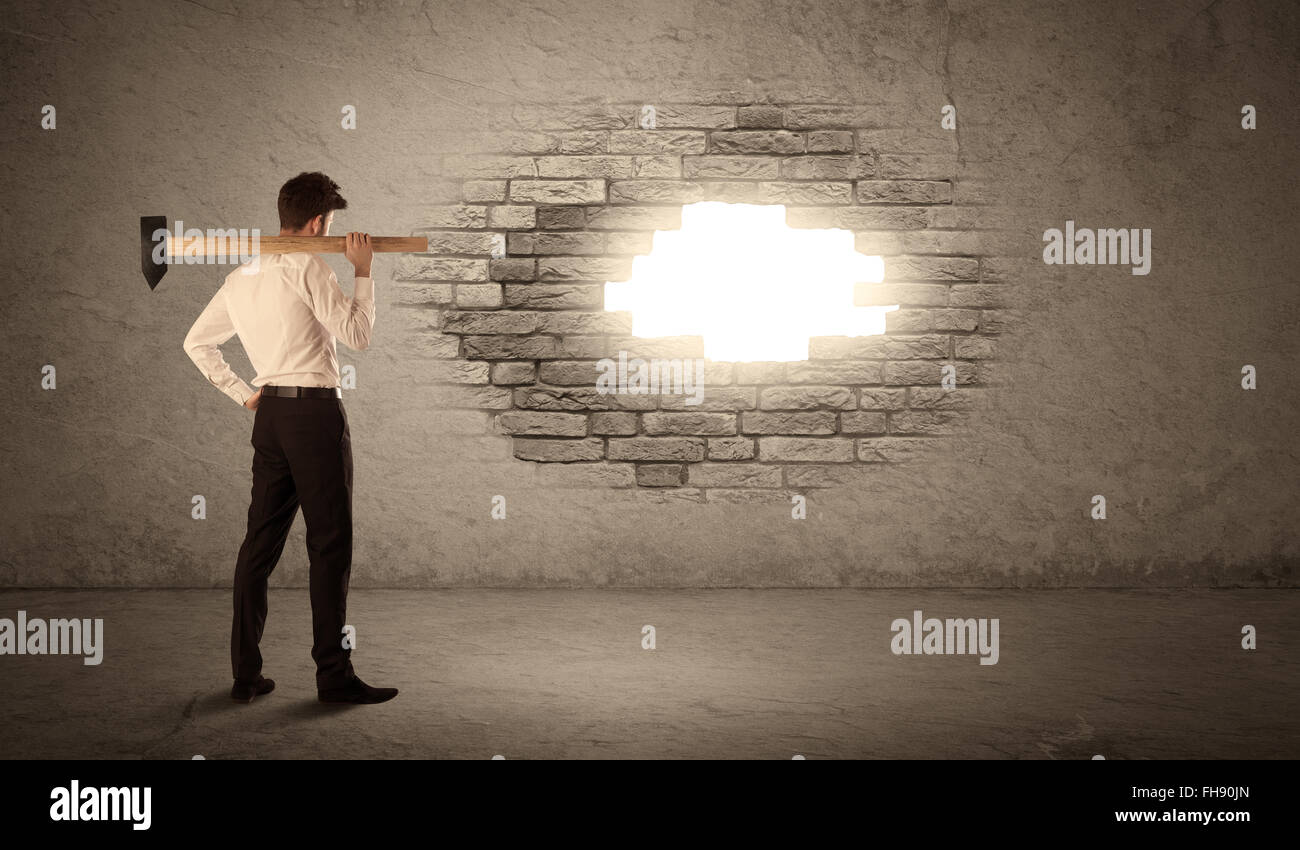 Business man hitting brick wall with hammer and opening a hole Stock ...