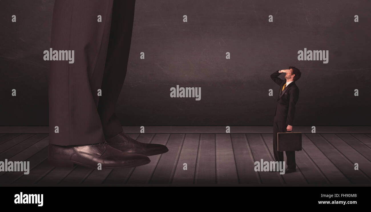 Big person with small businessman concept Stock Photo - Alamy