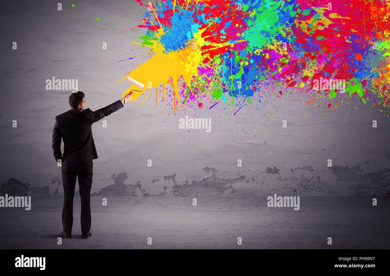 Sales person painting colorful splatter Stock Photo - Alamy