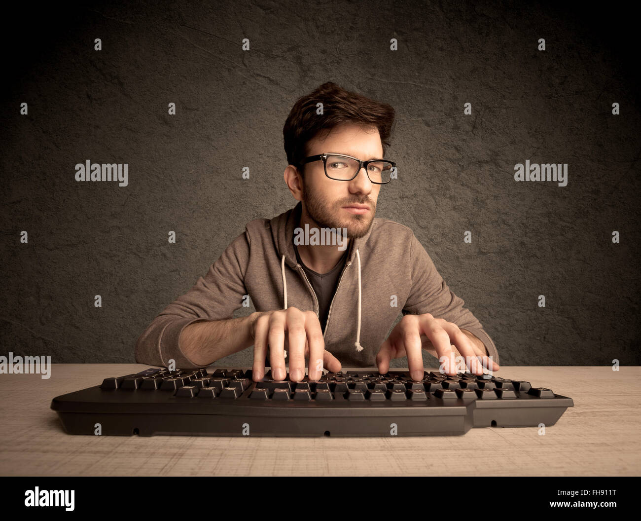 Computer geek typing on keyboard Stock Photo - Alamy