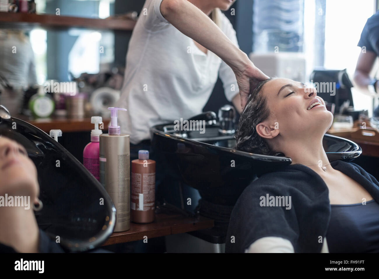 Woman in hair salon getting hair washed Stock Photo - Alamy