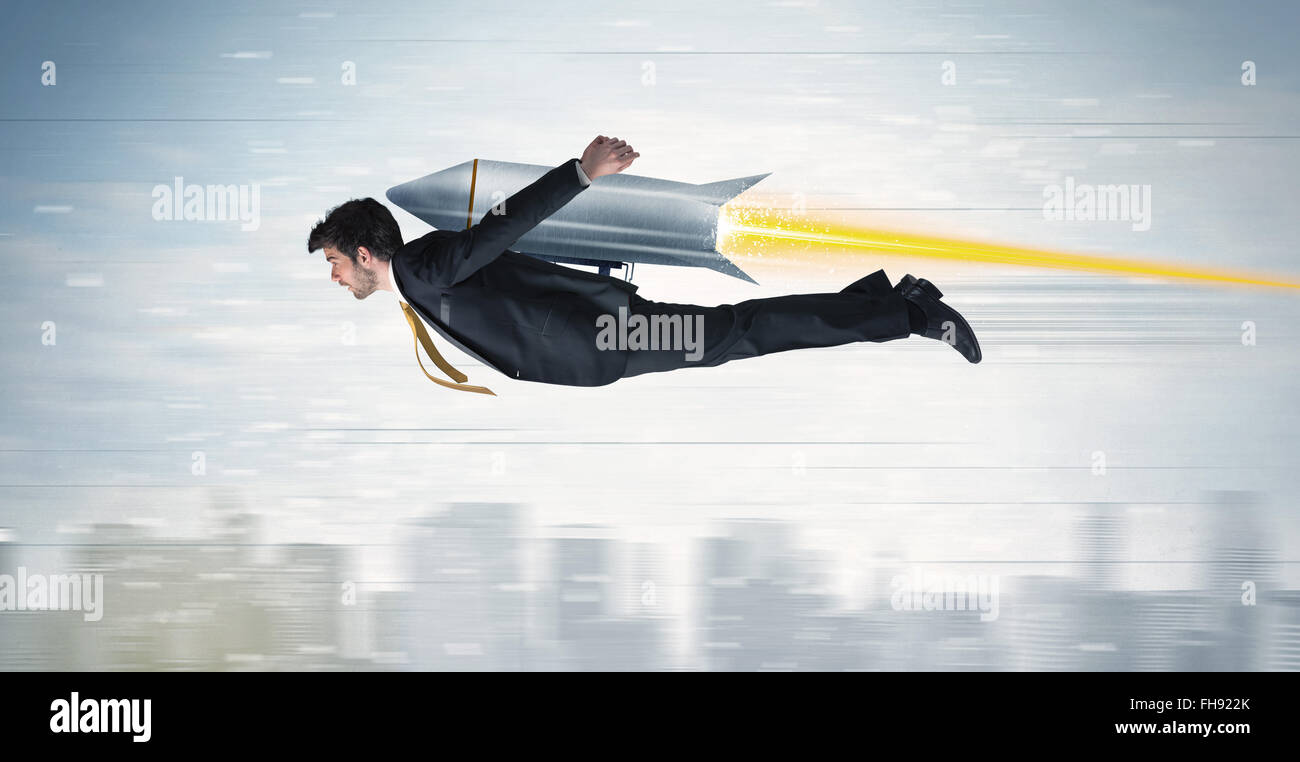 Superhero business man flying with jet pack rocket above the city Stock ...