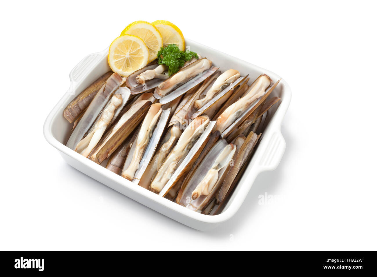 Dish with fresh cooked razor shells on white background Stock Photo - Alamy