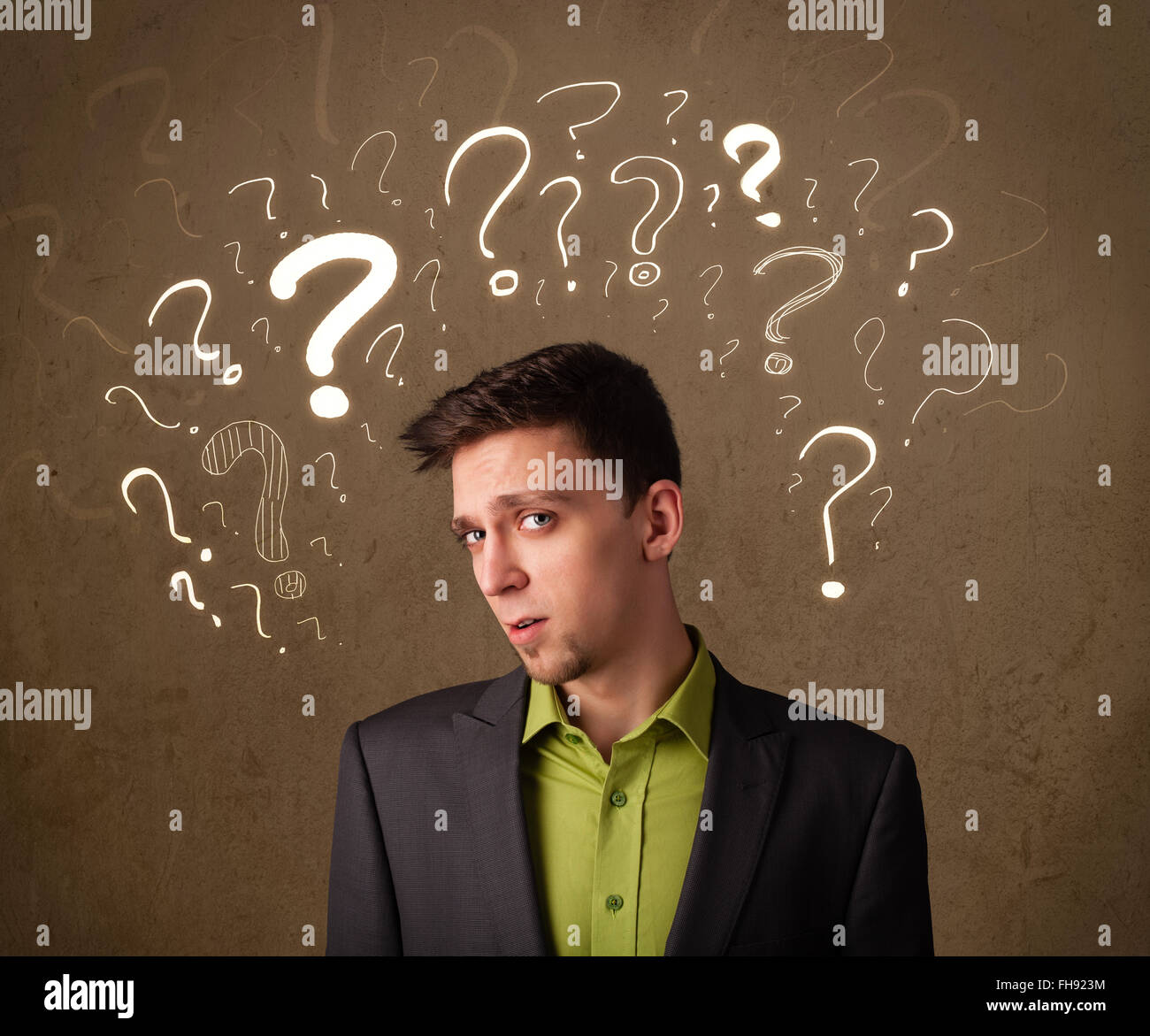 man with question mark symbols around his head Stock Photo - Alamy