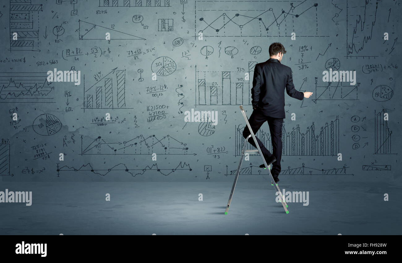 Man on ladder drawing charts Stock Photo - Alamy