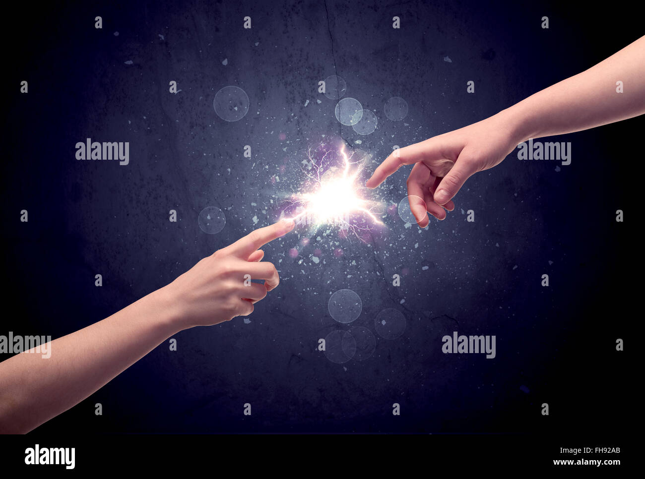 Hands reaching to light a spark Stock Photo - Alamy