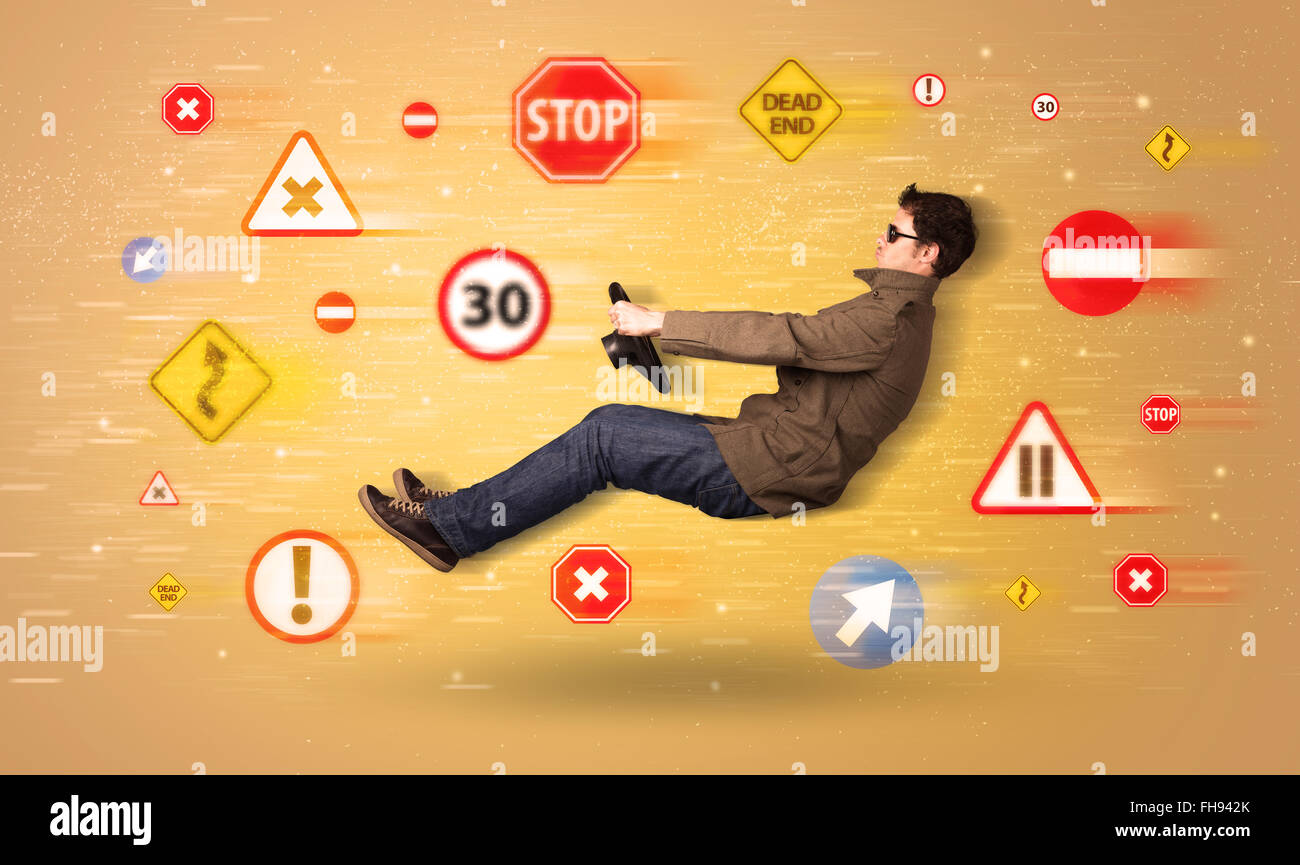 Young driver with road signs around him Stock Photo - Alamy