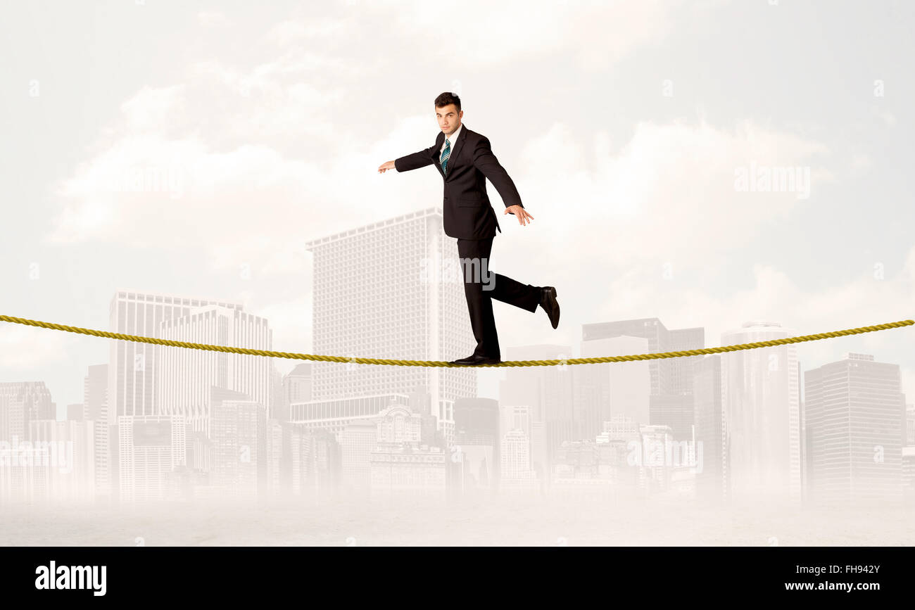 Business person balancing on golden rope Stock Photo - Alamy