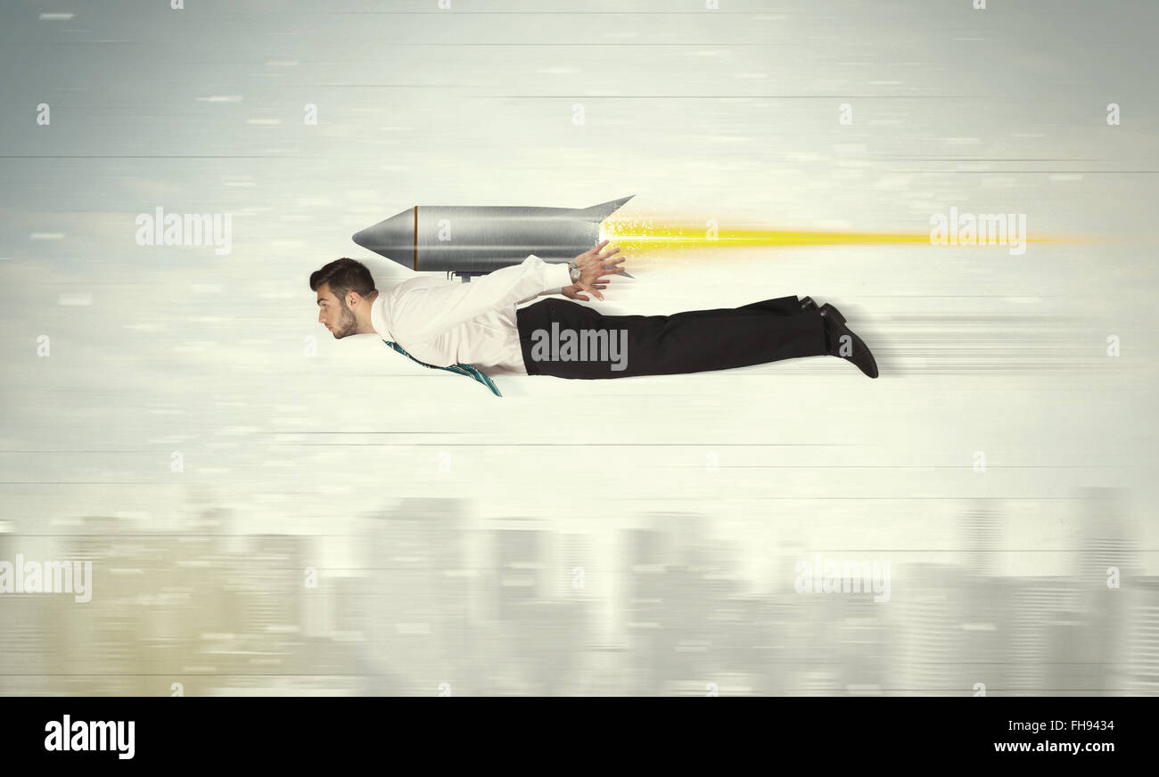 Superhero business man flying with jet pack rocket above the city Stock ...