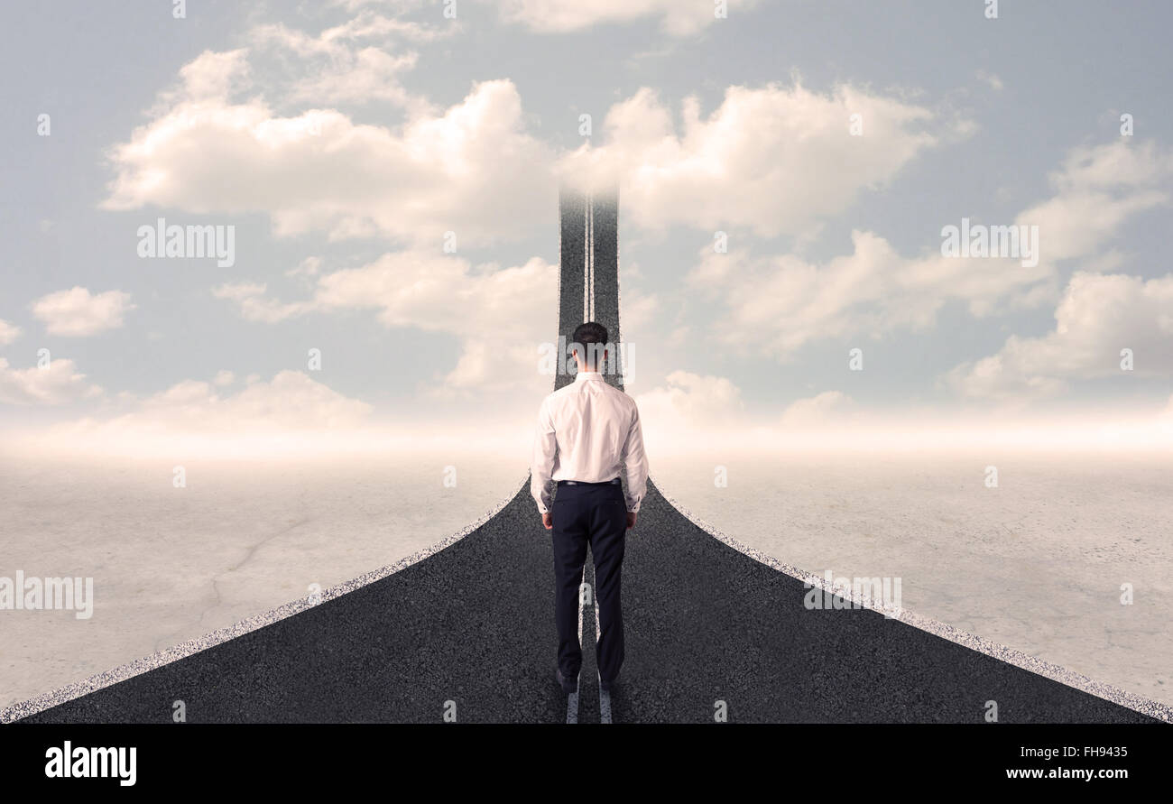 Businessman looking at 3d road that goes up in the sky Stock Photo - Alamy