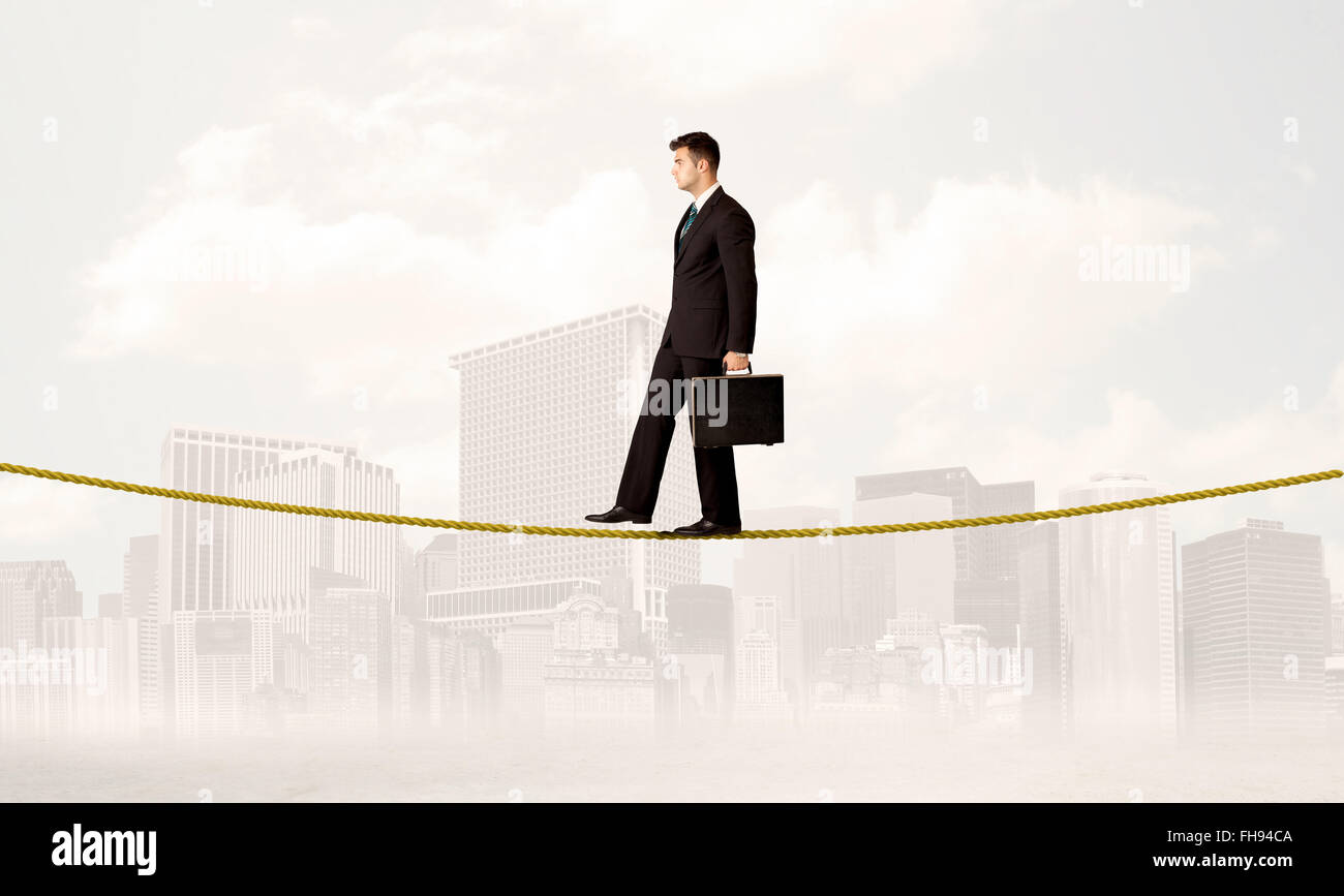 Business person balancing on golden rope Stock Photo - Alamy