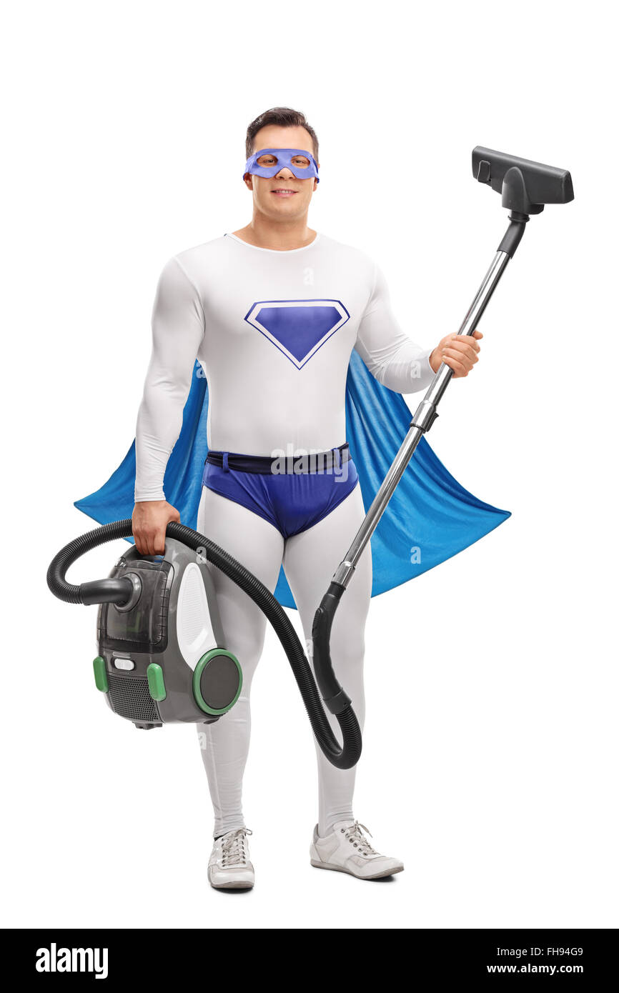 Full length portrait of a young man in a superhero costume holding a ...