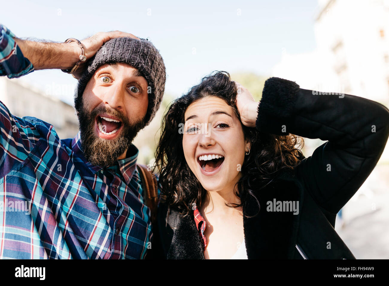 Playful young couple pulling faces Stock Photo - Alamy
