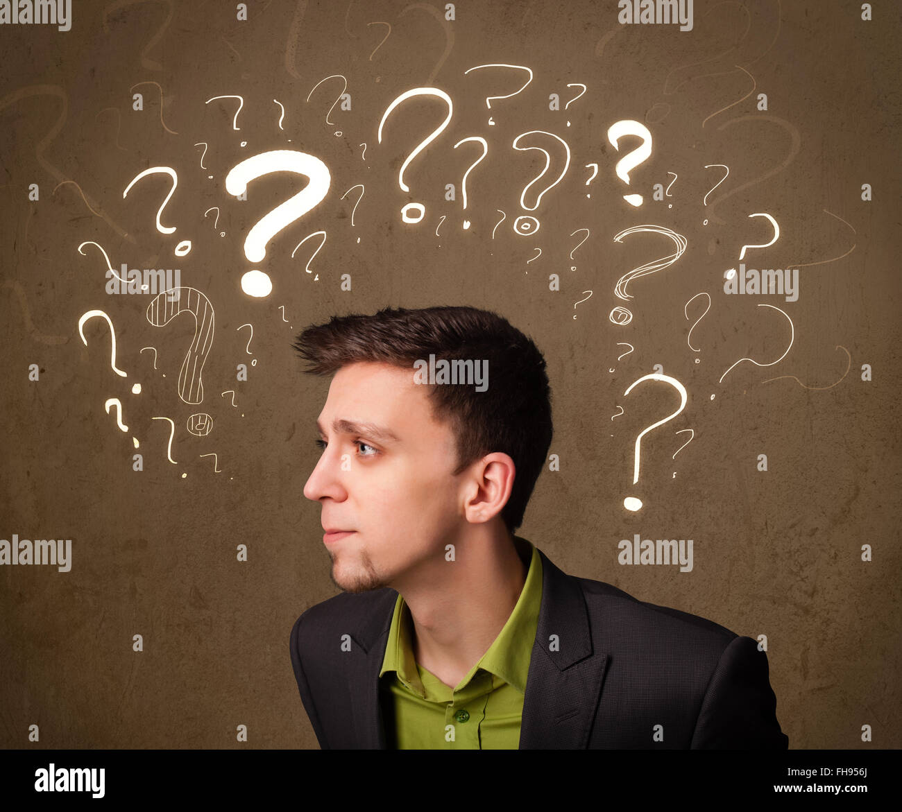 man with question mark symbols around his head Stock Photo - Alamy
