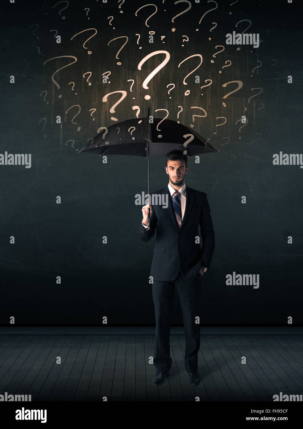 Businessman with umbrella and a lot of drawn question marks Stock Photo ...