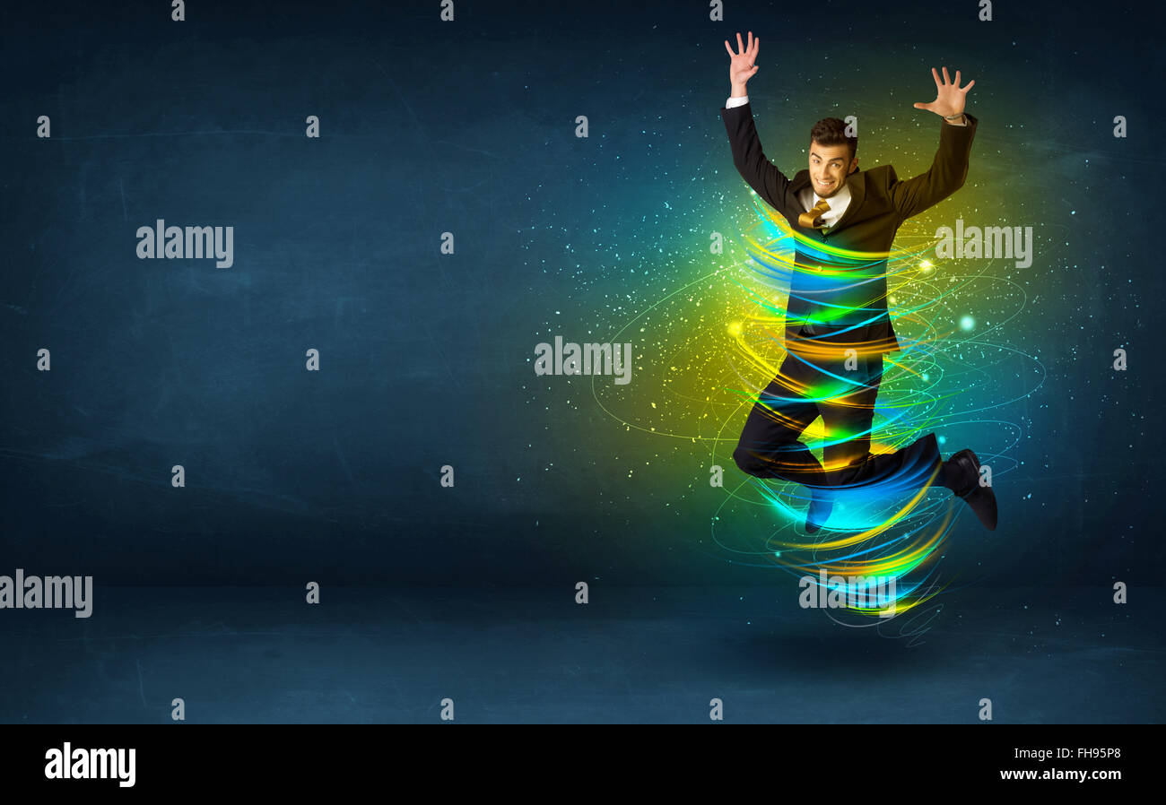 Excited business man jumping with energy colourful lines Stock Photo ...