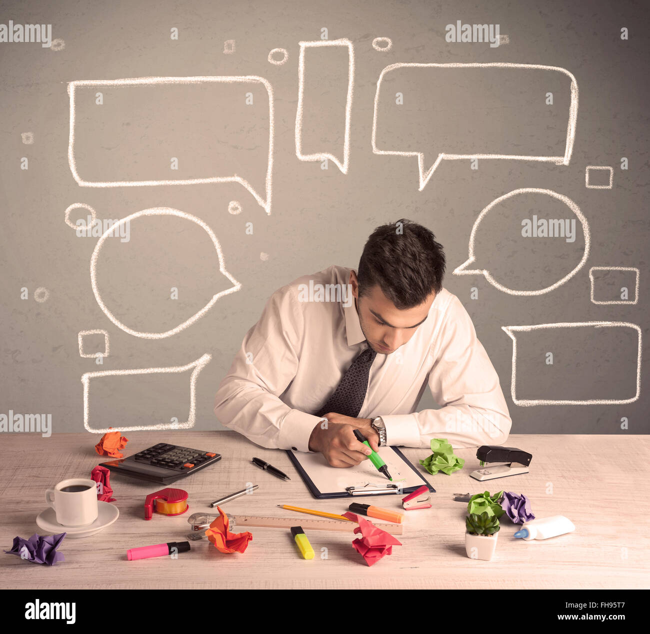 Busy office worker with drawn text bubbles Stock Photo - Alamy