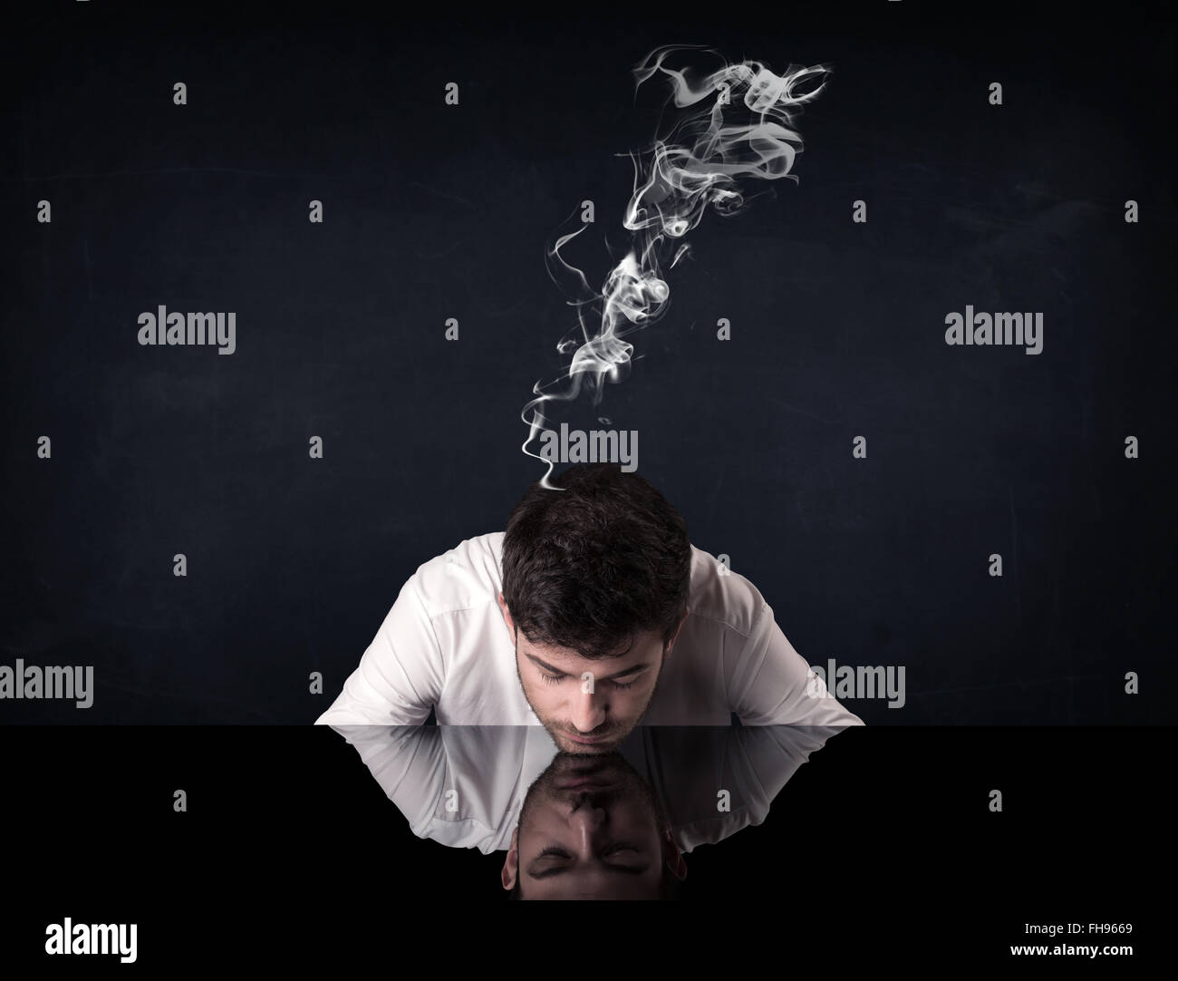 Depressed businessman with smoking head Stock Photo - Alamy