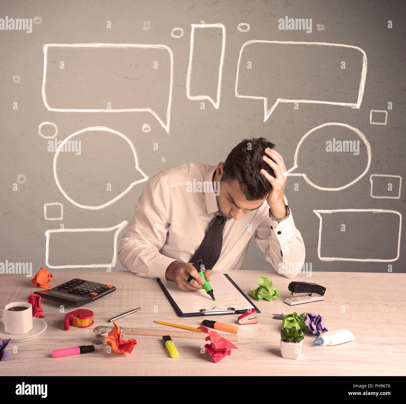 Busy office worker with drawn text bubbles Stock Photo - Alamy