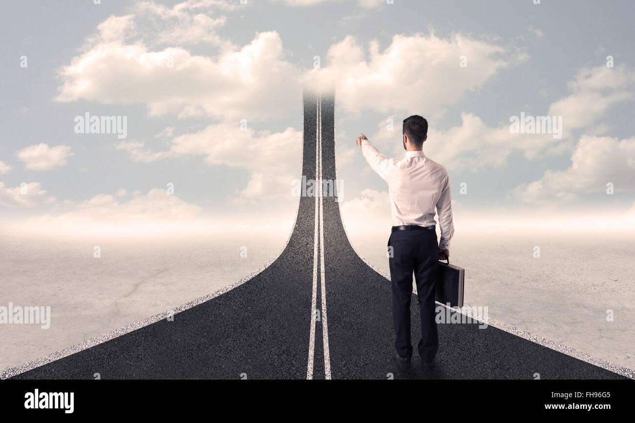 Businessman looking at 3d road that goes up in the sky Stock Photo - Alamy