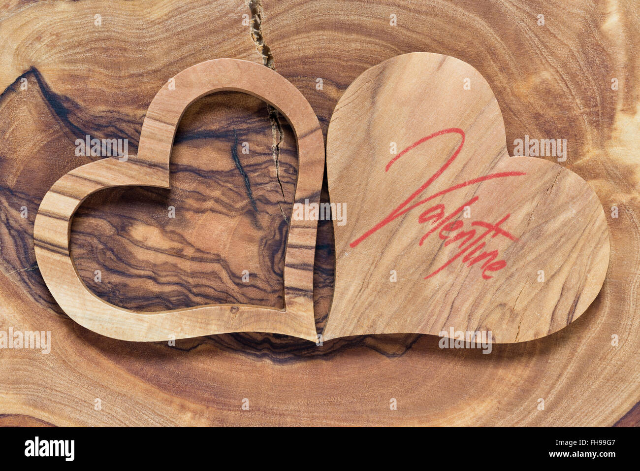 two wooden hearts on a wooden background, olive wood, copyspace ...